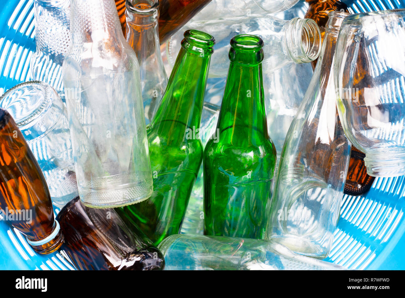 Glass bottles in blue waste basket Stock Photo - Alamy
