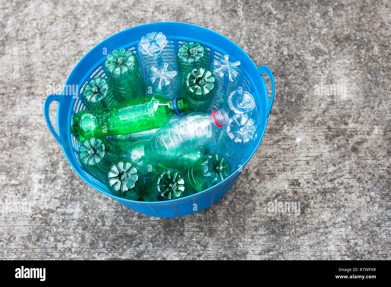 Plastic bottles in blue waste basket Stock Photo - Alamy