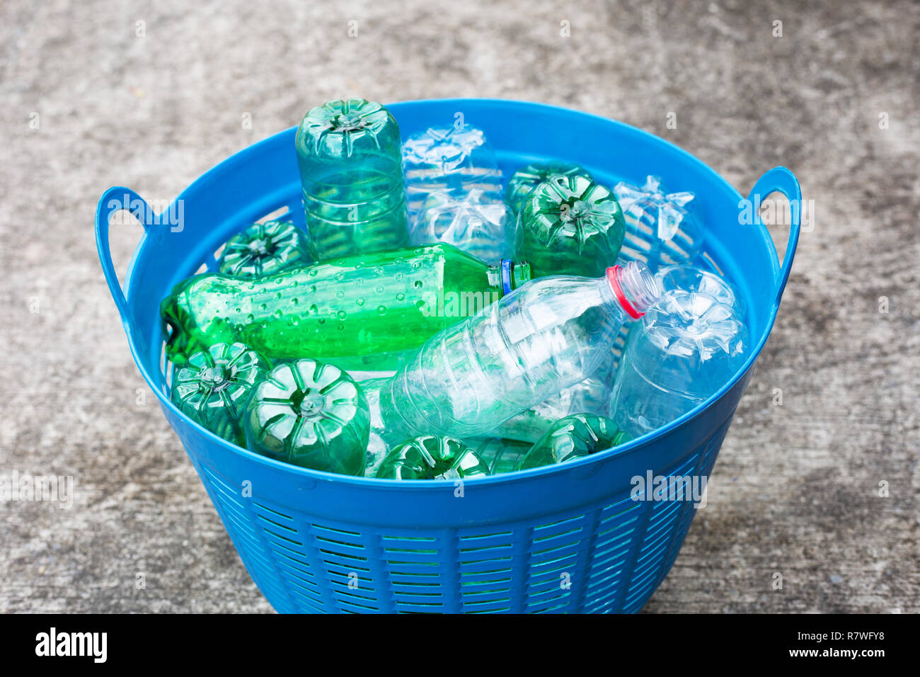 Plastic bottles in blue waste basket Stock Photo - Alamy