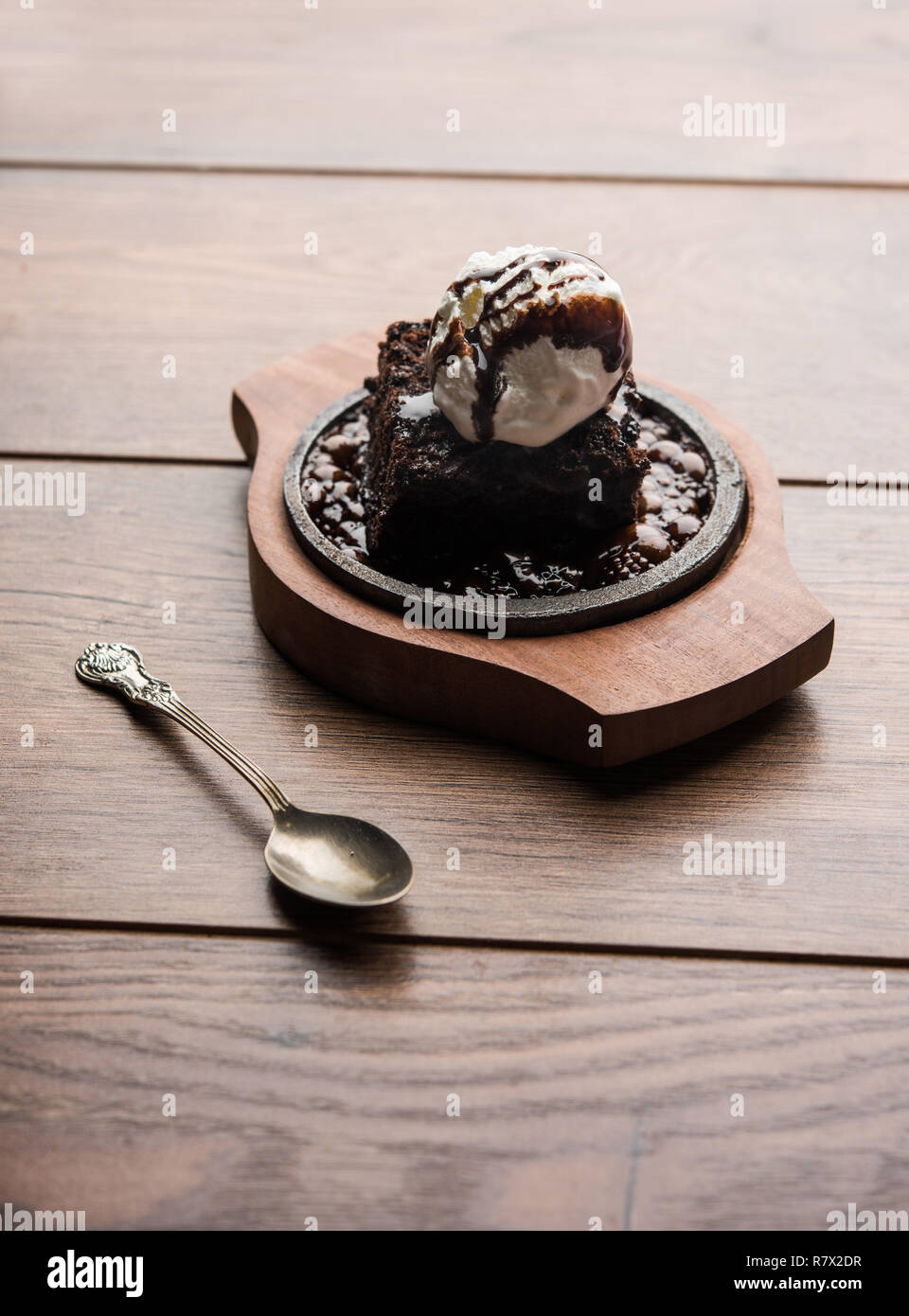 sizzling chocolate brownie is a sweet dish made using scoop of ice ...
