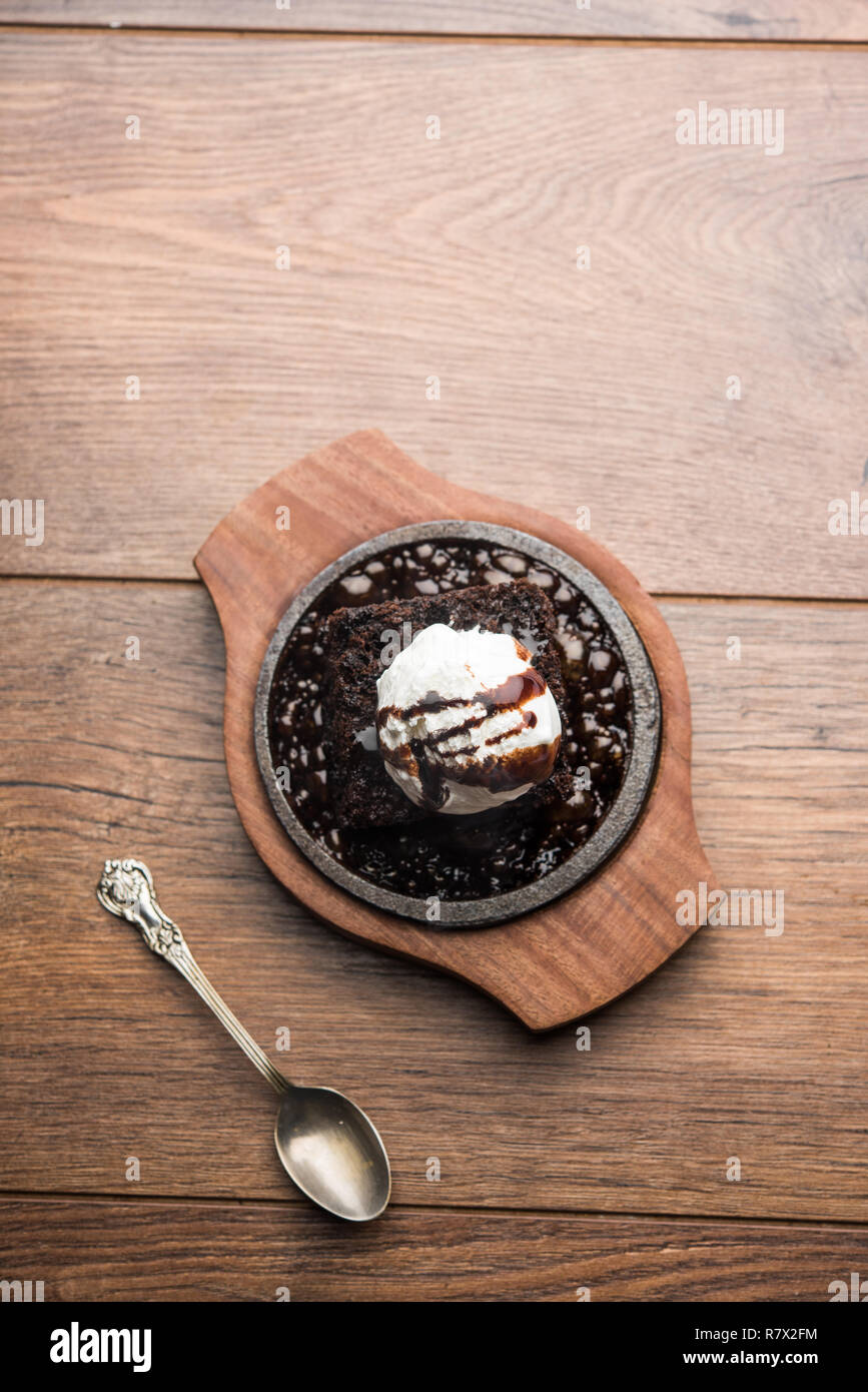 sizzling chocolate brownie is a sweet dish made using scoop of ice ...