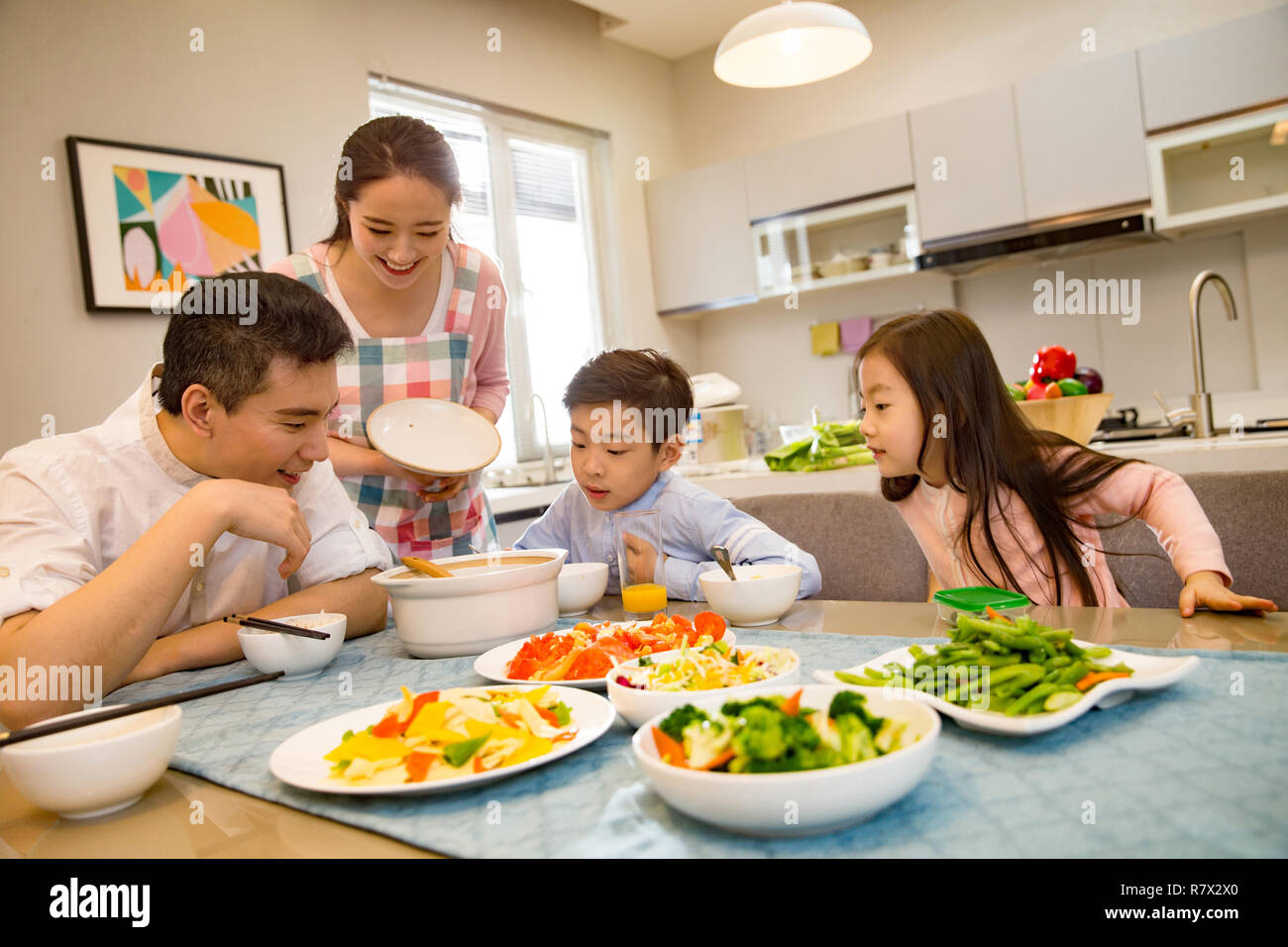 Happy family at dinner Stock Photo - Alamy