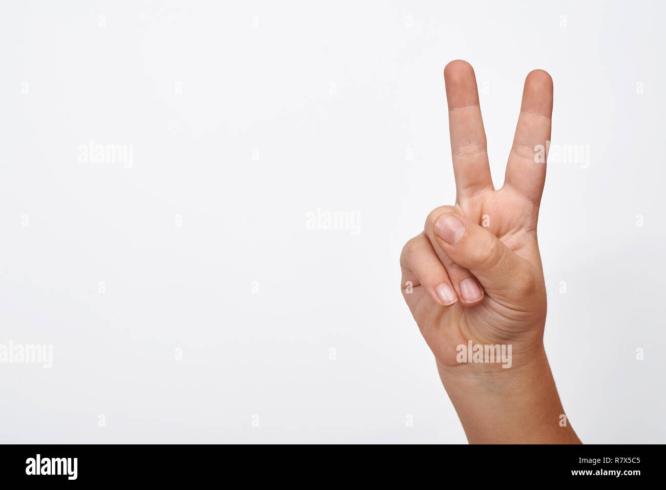 Child hand shows two finger displaying peace and win sign Stock Photo ...