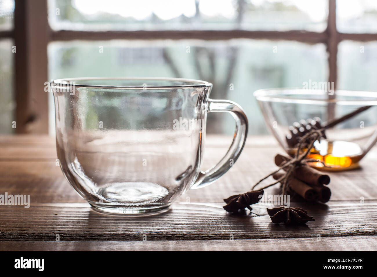 Empty tea glass near window with anise, cinnamon and honey Stock Photo ...
