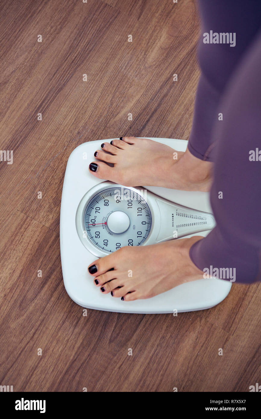 Young woman weight measurement Stock Photo - Alamy
