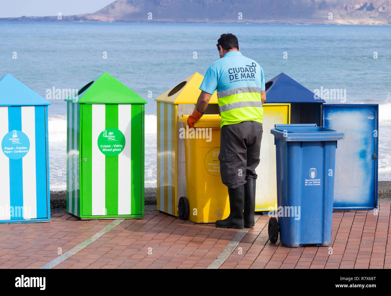People Recycling On Beach