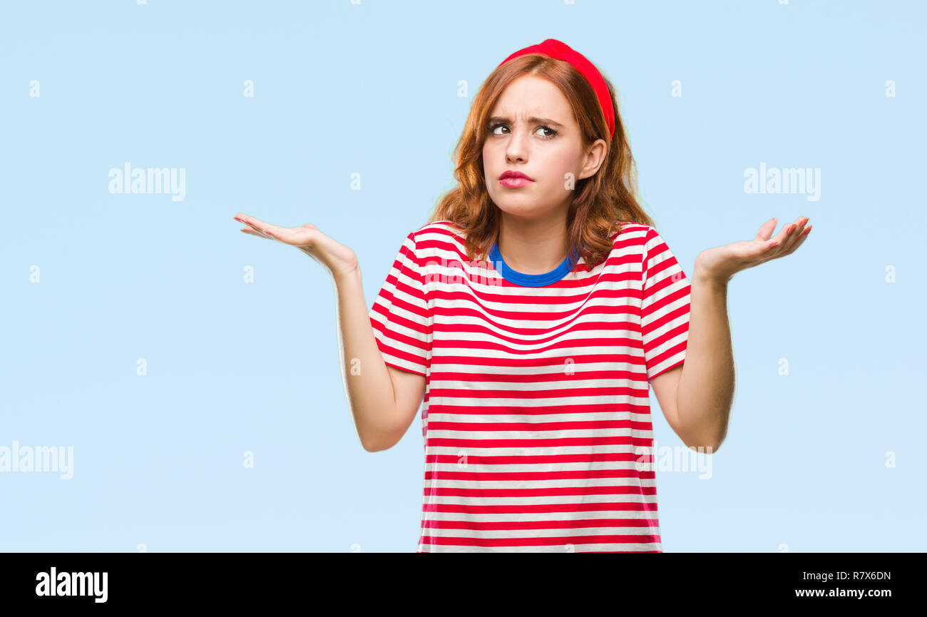 Young beautiful woman over isolated background clueless and confused ...