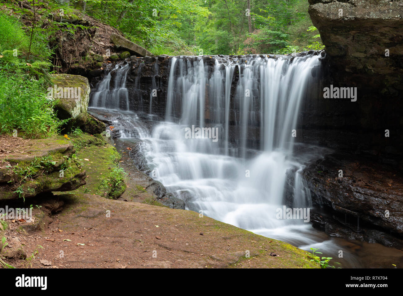 A waterfall along Crum Creek pouring over ruins left formerly as a ...