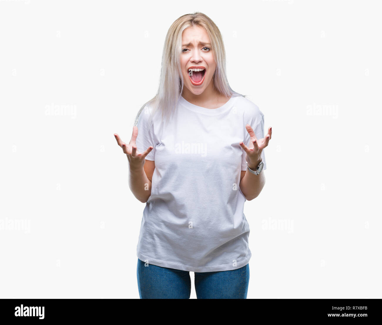 Young blonde woman over isolated background crazy and mad shouting and ...