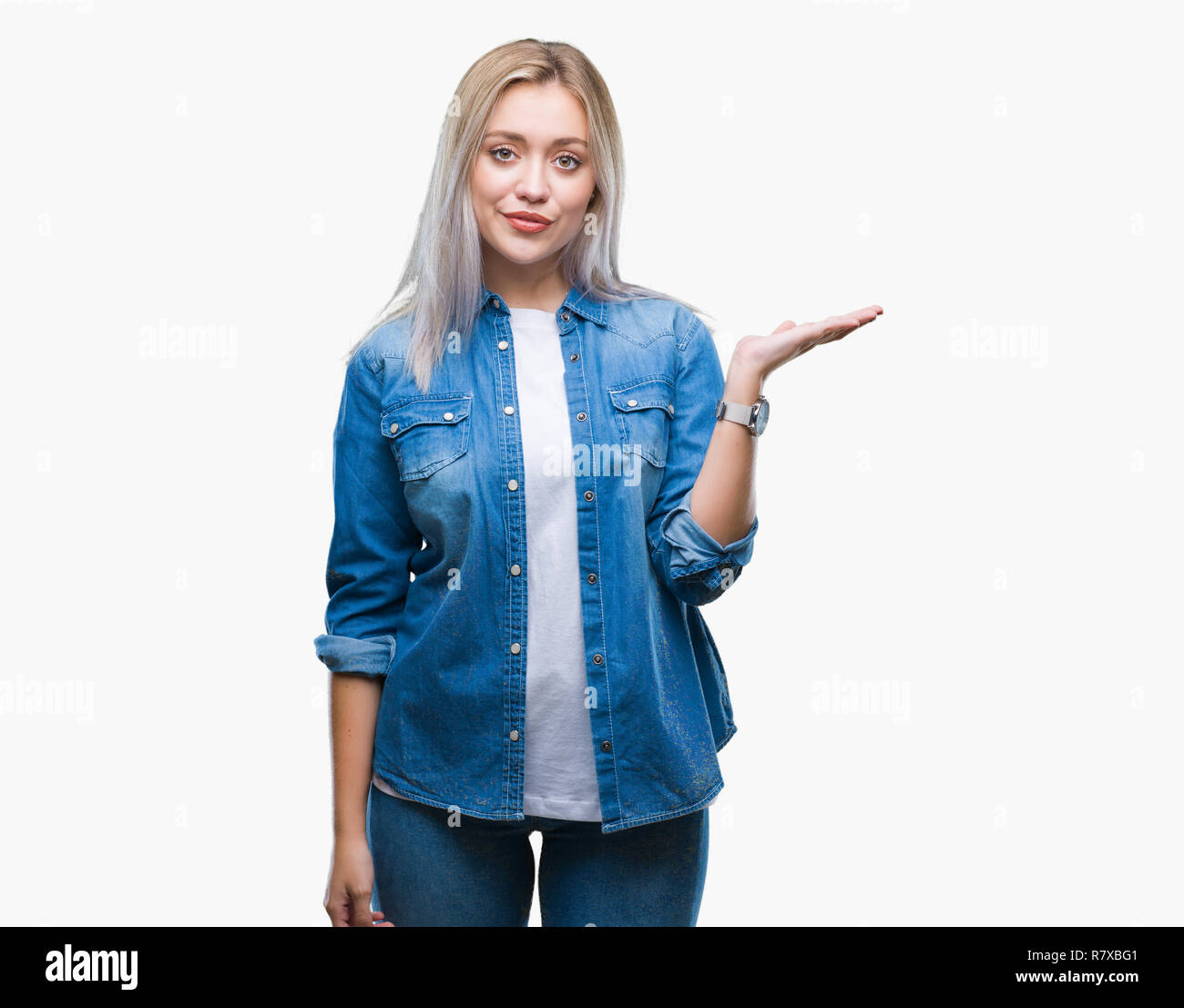 Young blonde woman over isolated background smiling cheerful presenting ...