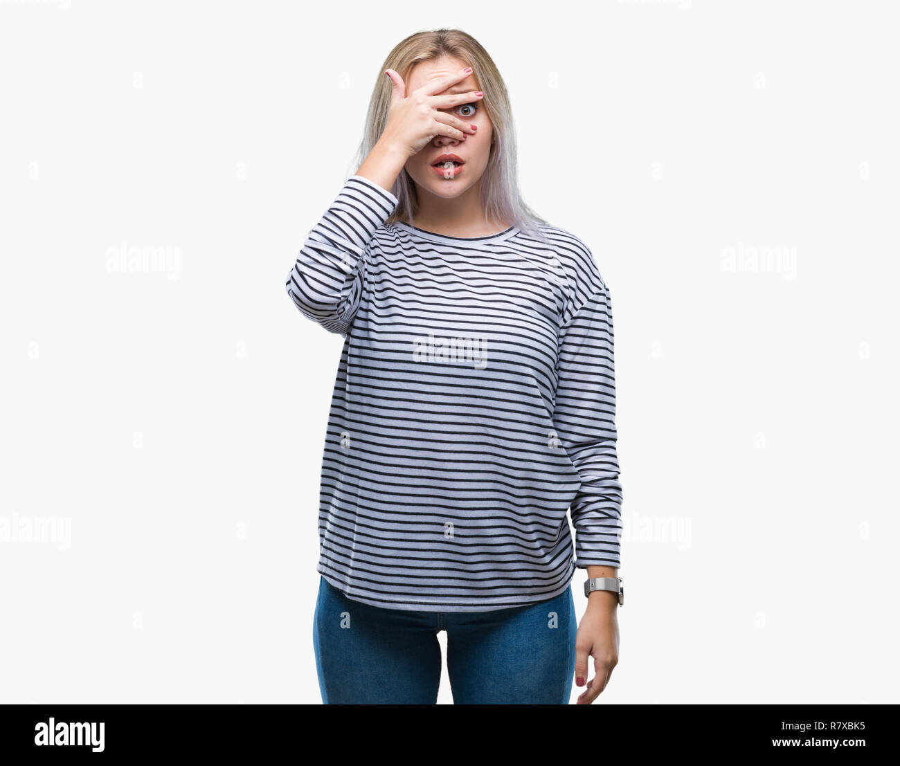 Young blonde woman over isolated background peeking in shock covering ...