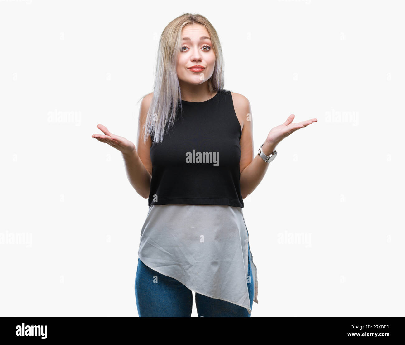 Young blonde woman over isolated background clueless and confused ...