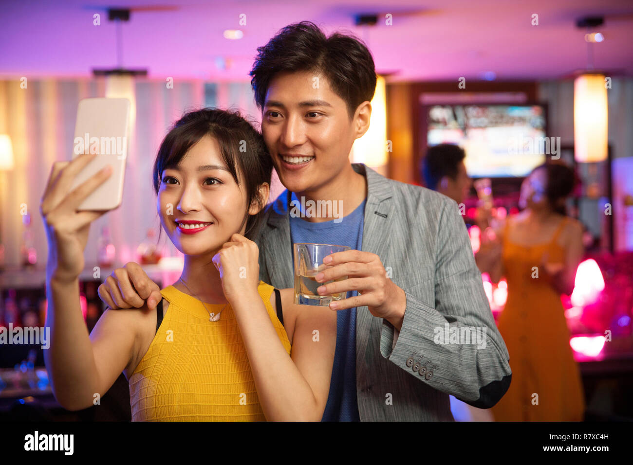Young couples to use mobile phones Stock Photo - Alamy