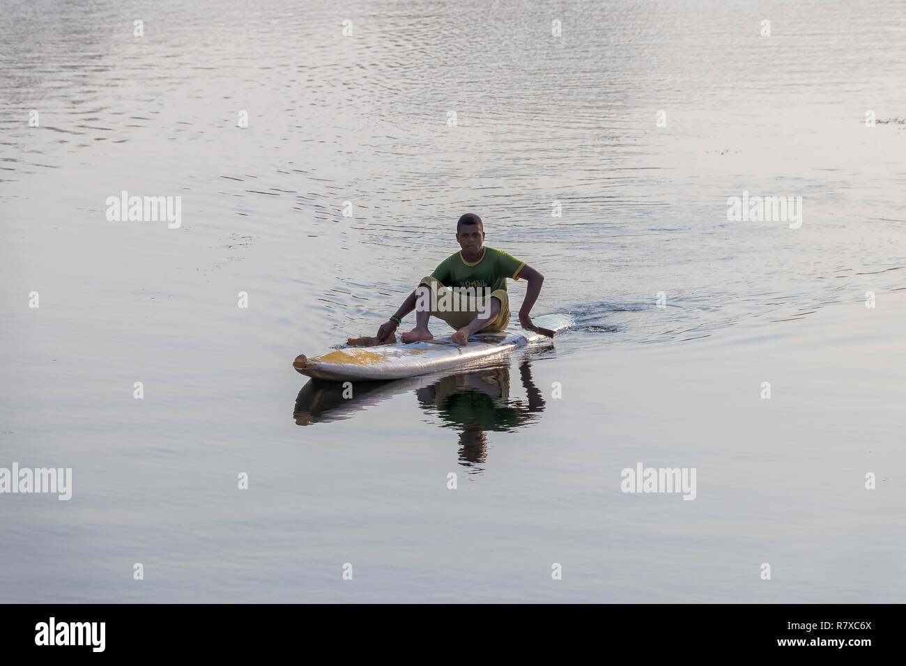 Aswan, Egypt - September 13, 2018: Egyptian kid in a surf board in Nile ...