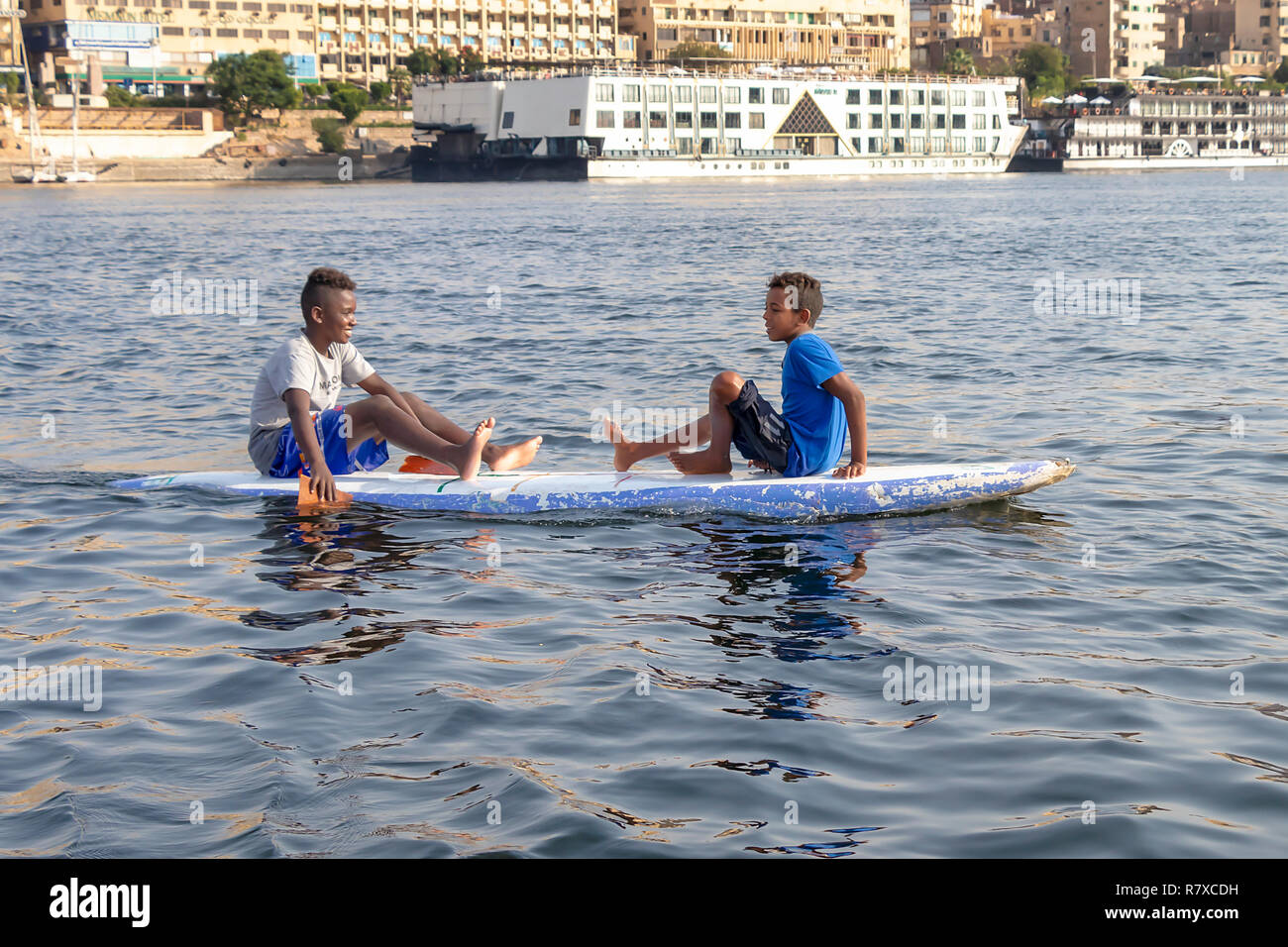 Aswan, Egypt - September 13, 2018: Egyptian children in a surf board in ...