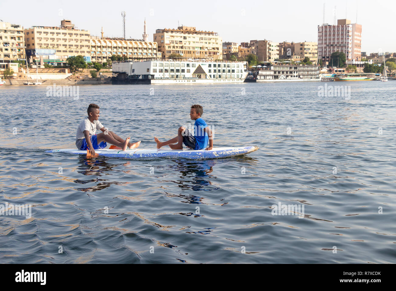Aswan, Egypt - September 13, 2018: Egyptian children in a surf board in ...