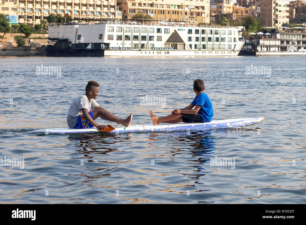Aswan, Egypt - September 13, 2018: Egyptian children in a surf board in ...