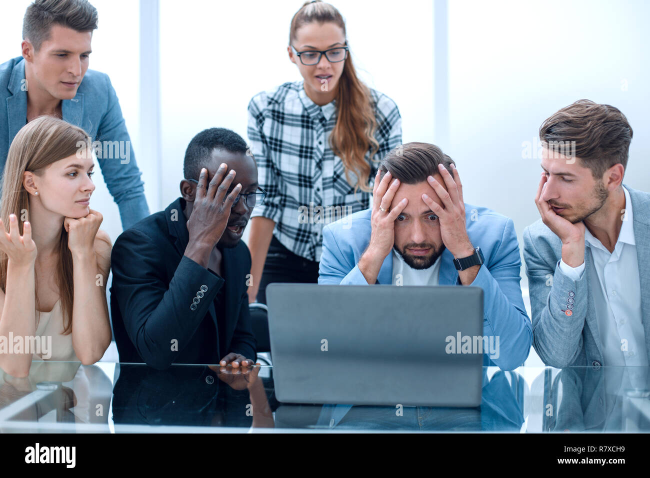 group of people looking at laptop Stock Photo - Alamy