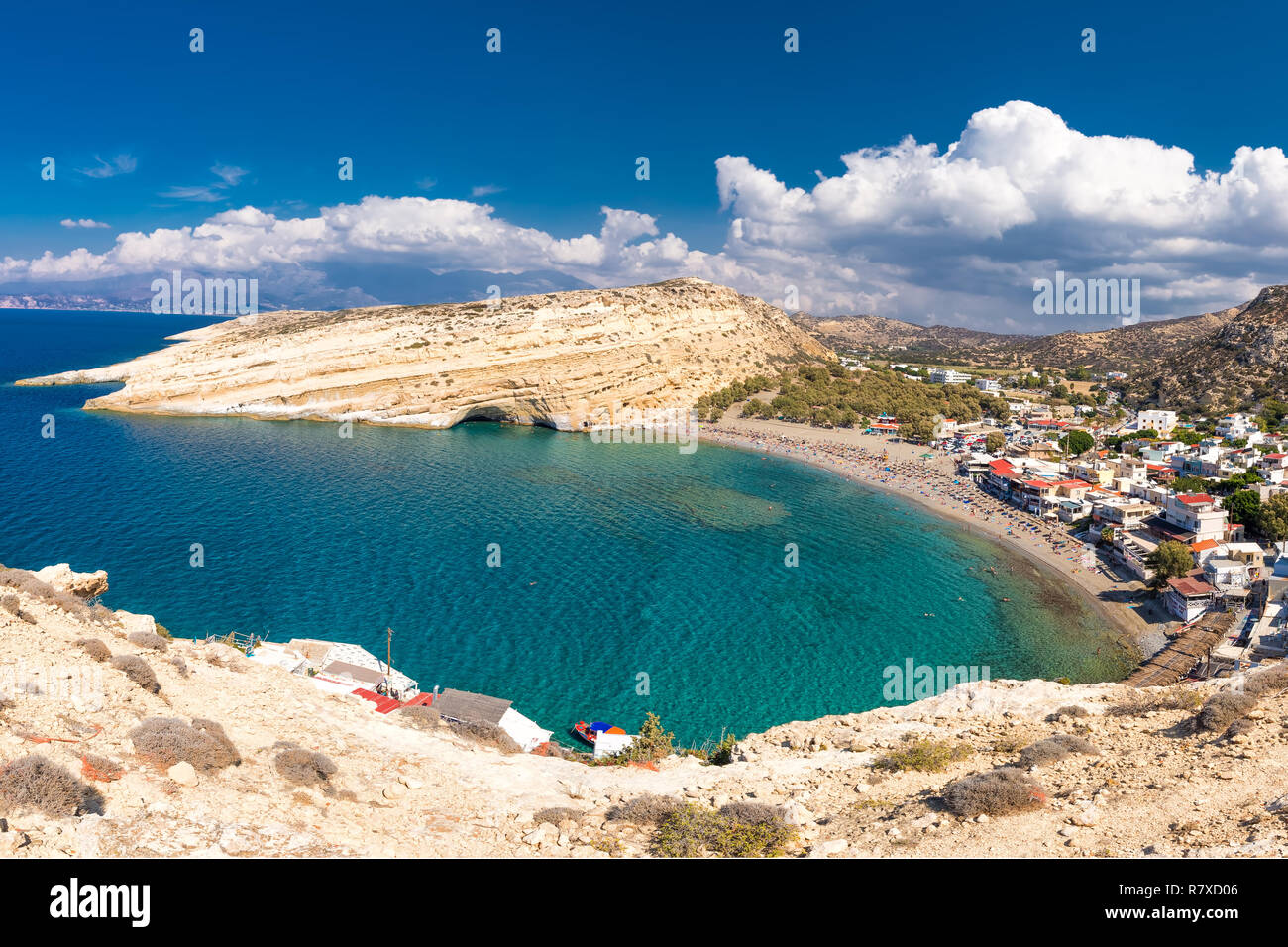 Aerial view of Matala beach on Crete island with azure clear water ...