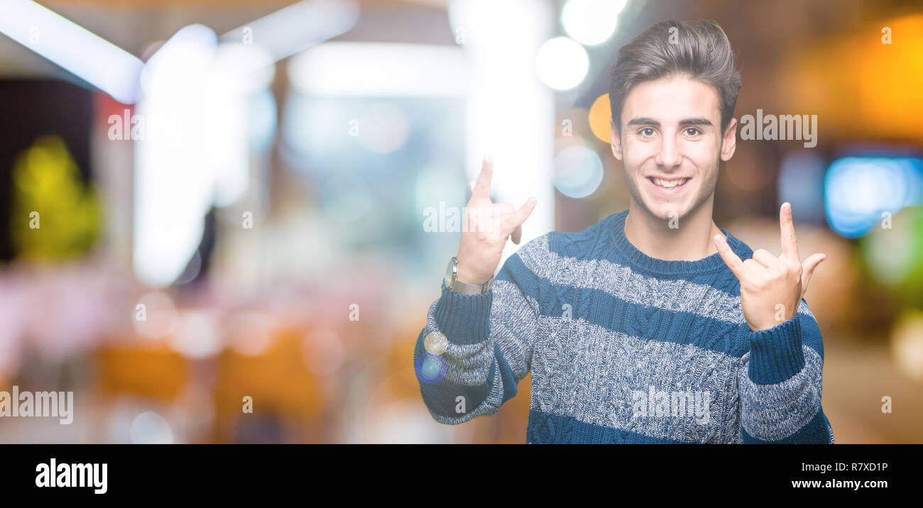Young handsome man over isolated background shouting with crazy ...