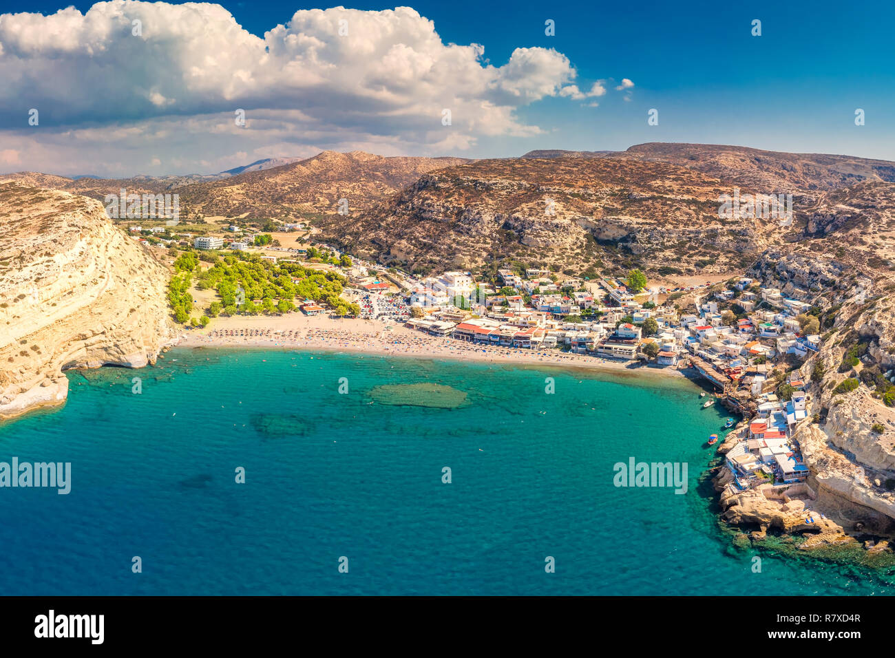 Aerial view of Matala beach on Crete island with azure clear water ...