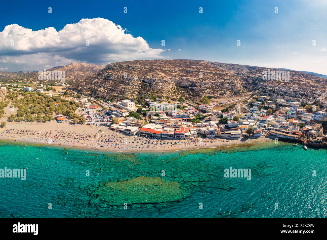 Aerial view of Matala beach on Crete island with azure clear water ...