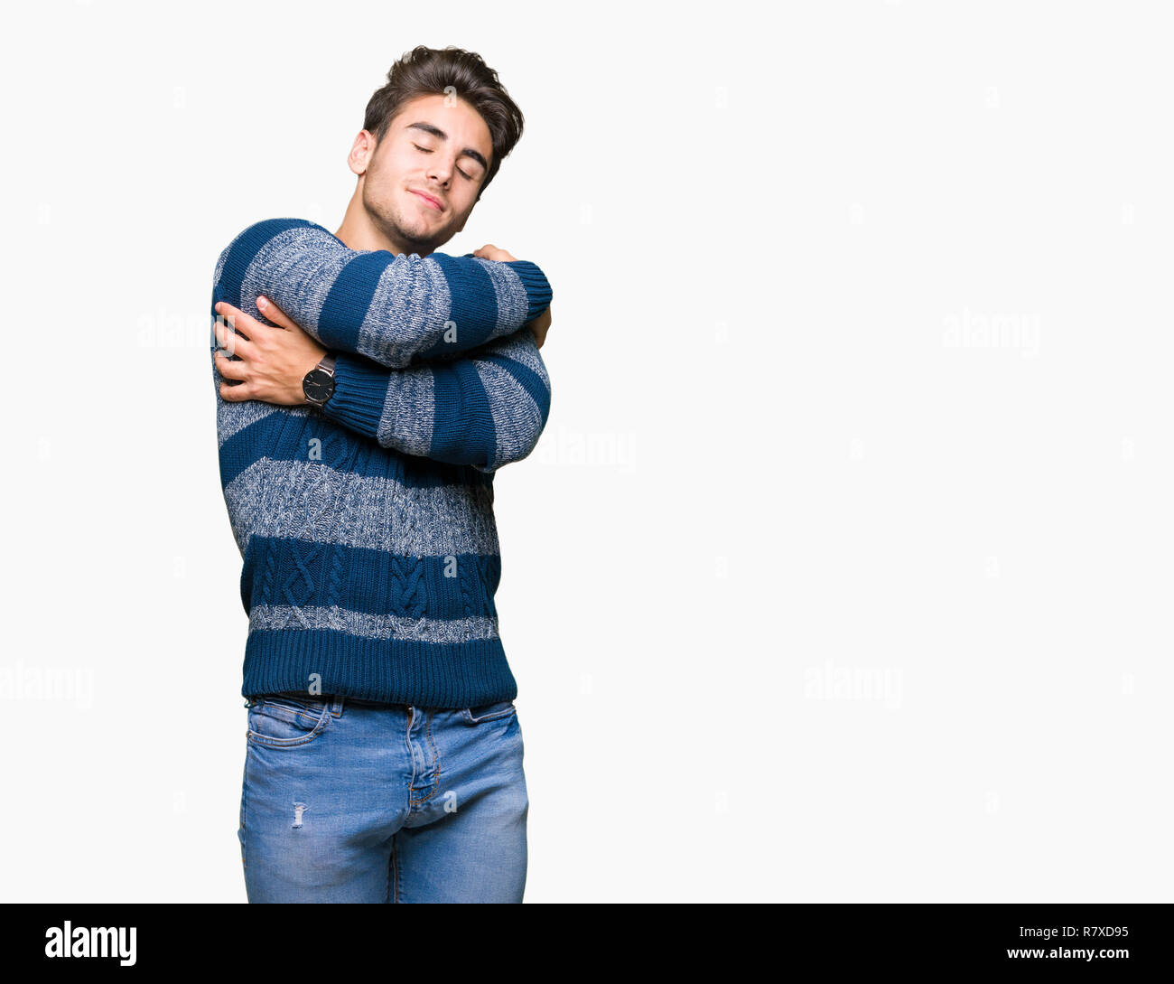Young handsome man over isolated background Hugging oneself happy and ...