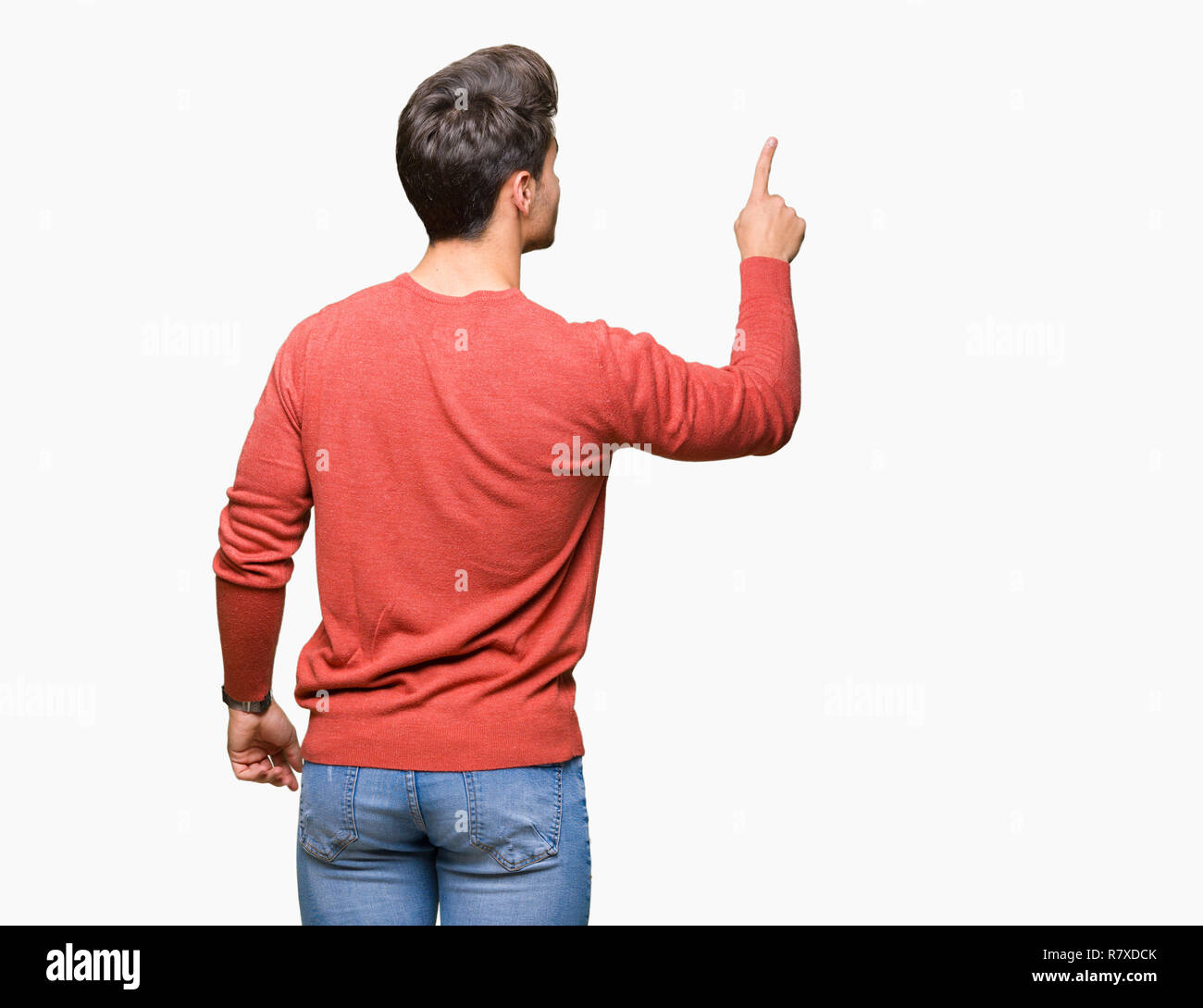 Young handsome man over isolated background Posing backwards pointing ...