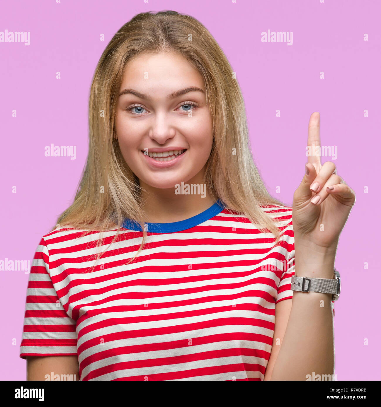 Young caucasian woman over isolated background showing and pointing up ...