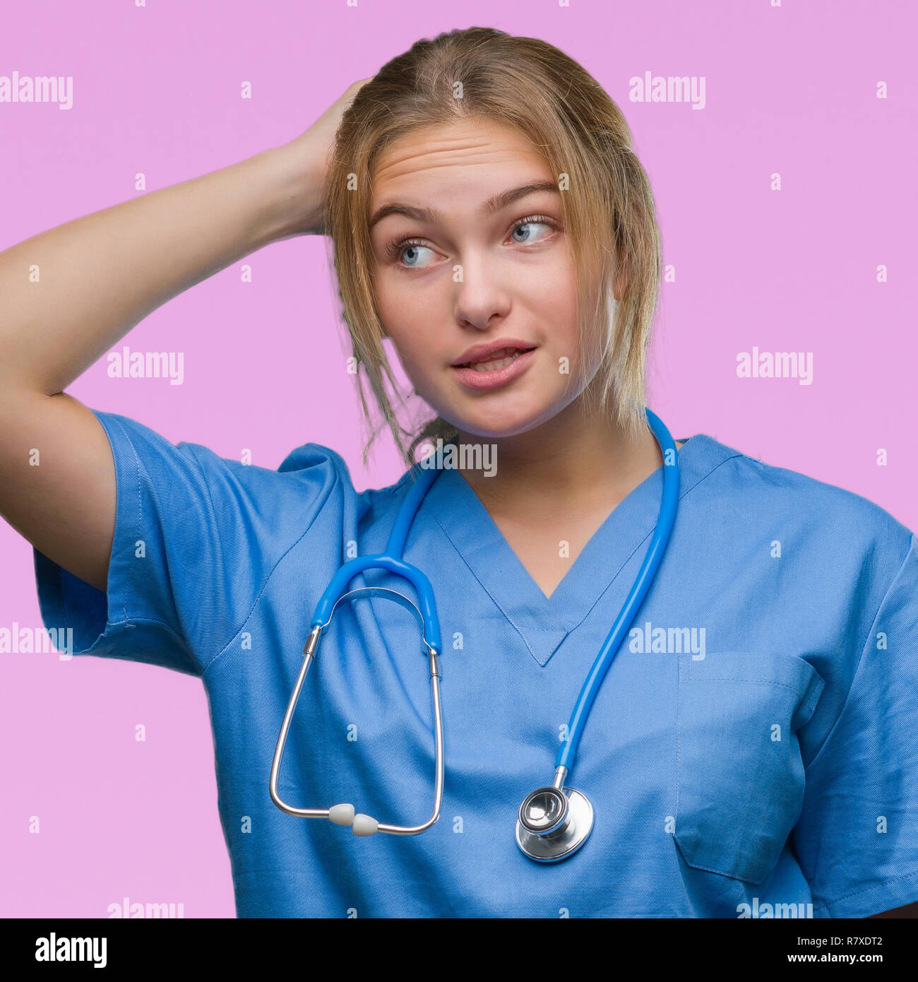 Young caucasian doctor woman wearing surgeon uniform over isolated ...