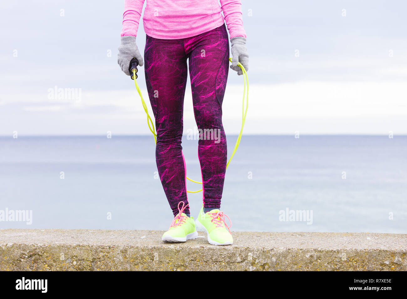 Woman athlete fit girl training outdoor with jumping skipping rope ...
