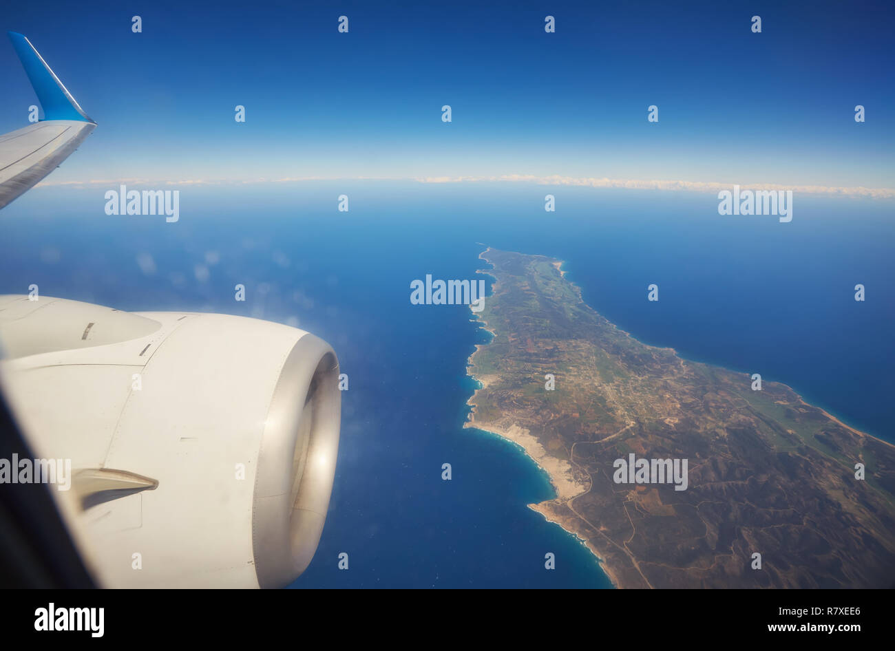 The plane is flying over the island of Cyprus. Airplane wing in flight ...