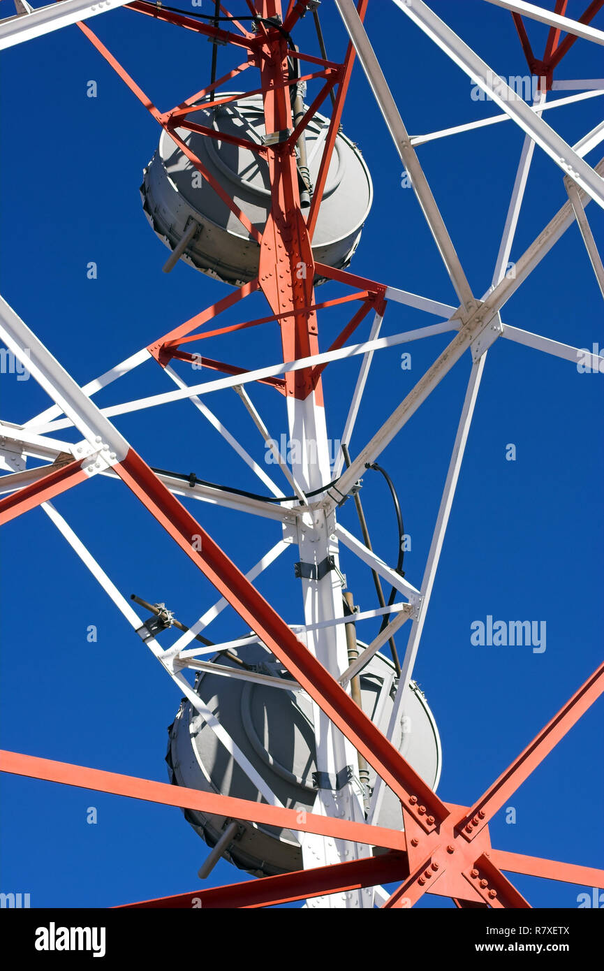 Dynamic perspective of a red and white communication tower with ...
