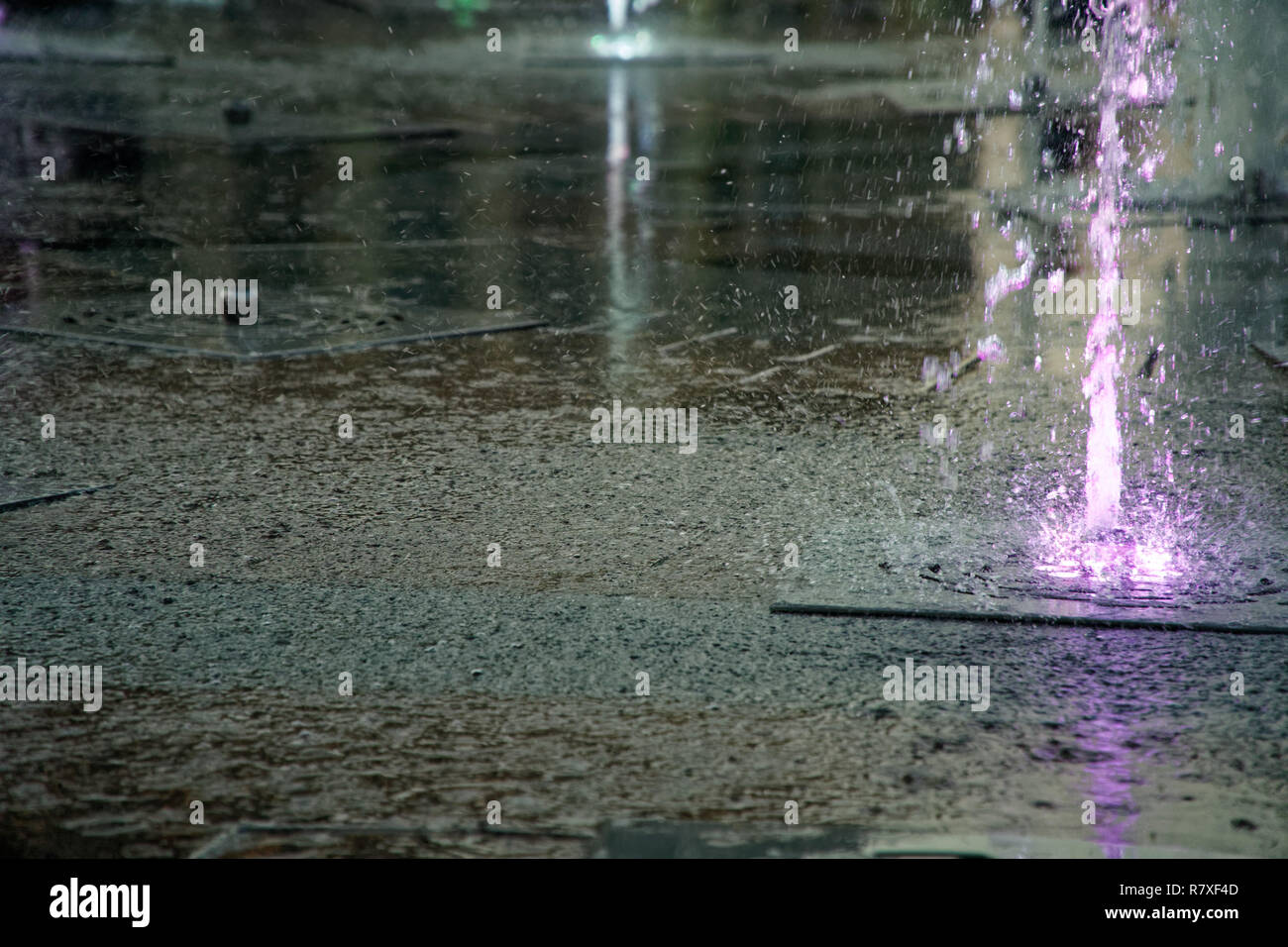 Light fountain, colorful splashing drops in the night Stock Photo - Alamy
