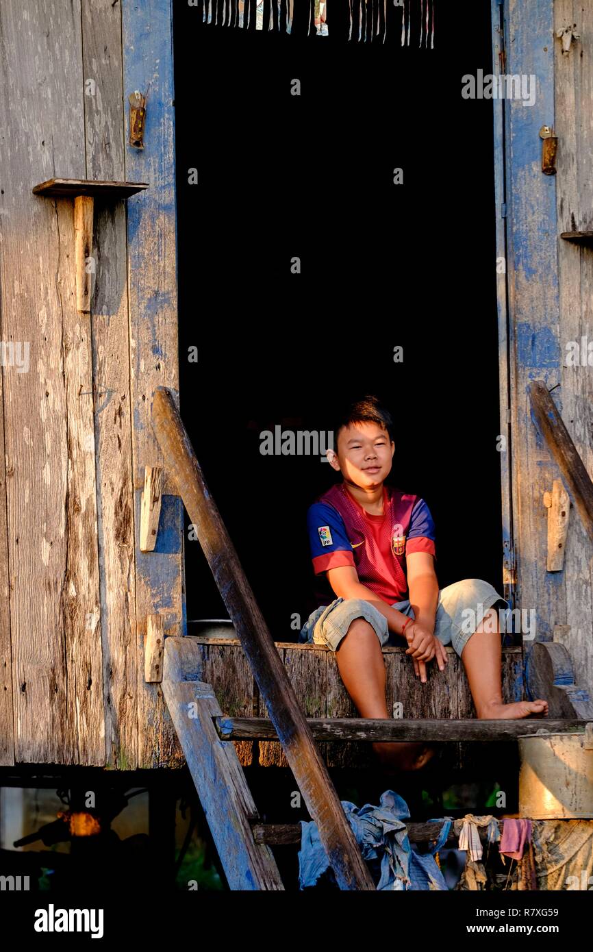 Cambodia, Kompong Thom province, Kompong Thom or Kampong Thom, boy at his home's door Stock ...