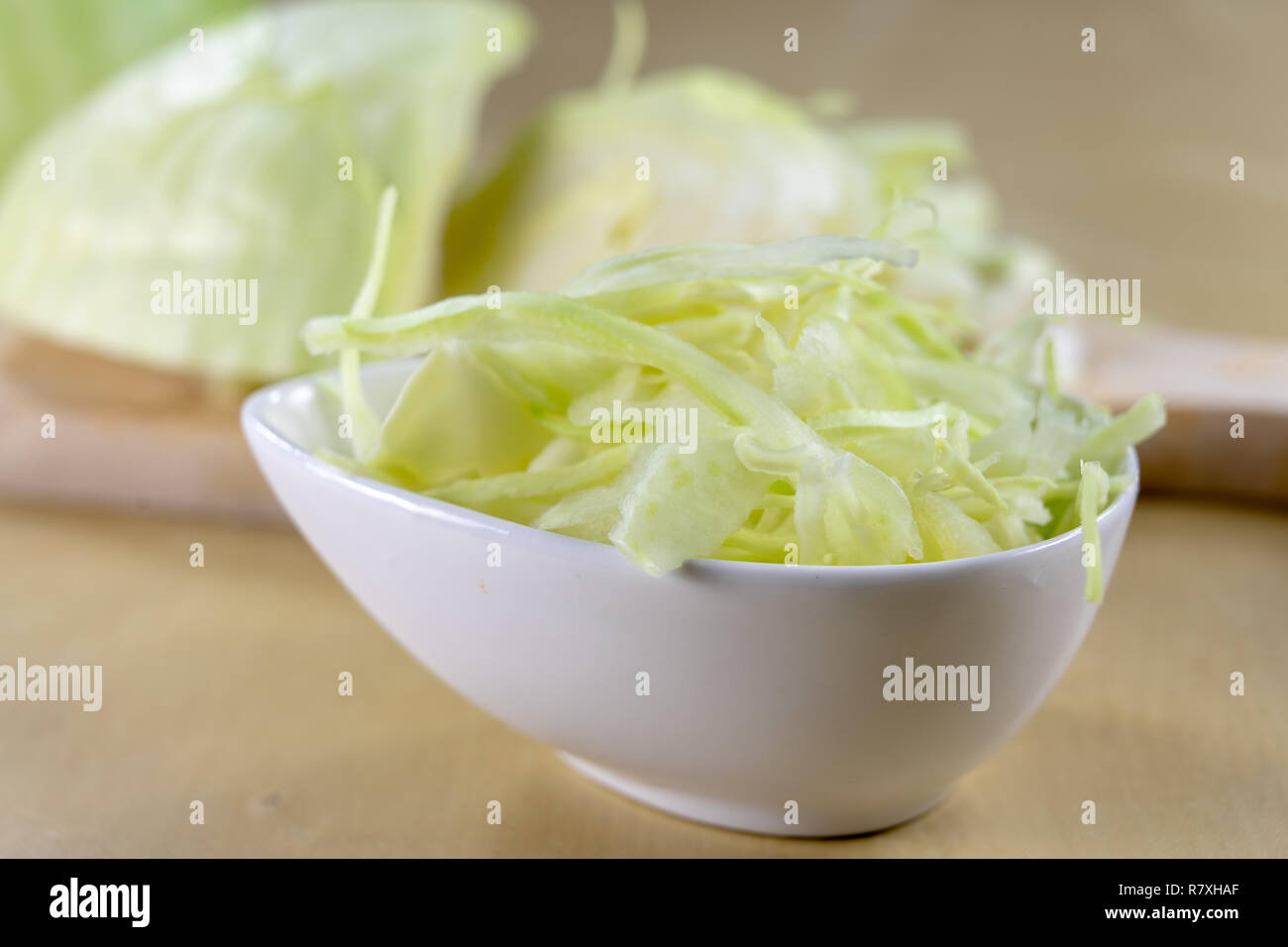 Fresh white cabbage cut into strips on the kitchen table. Vegetables ...
