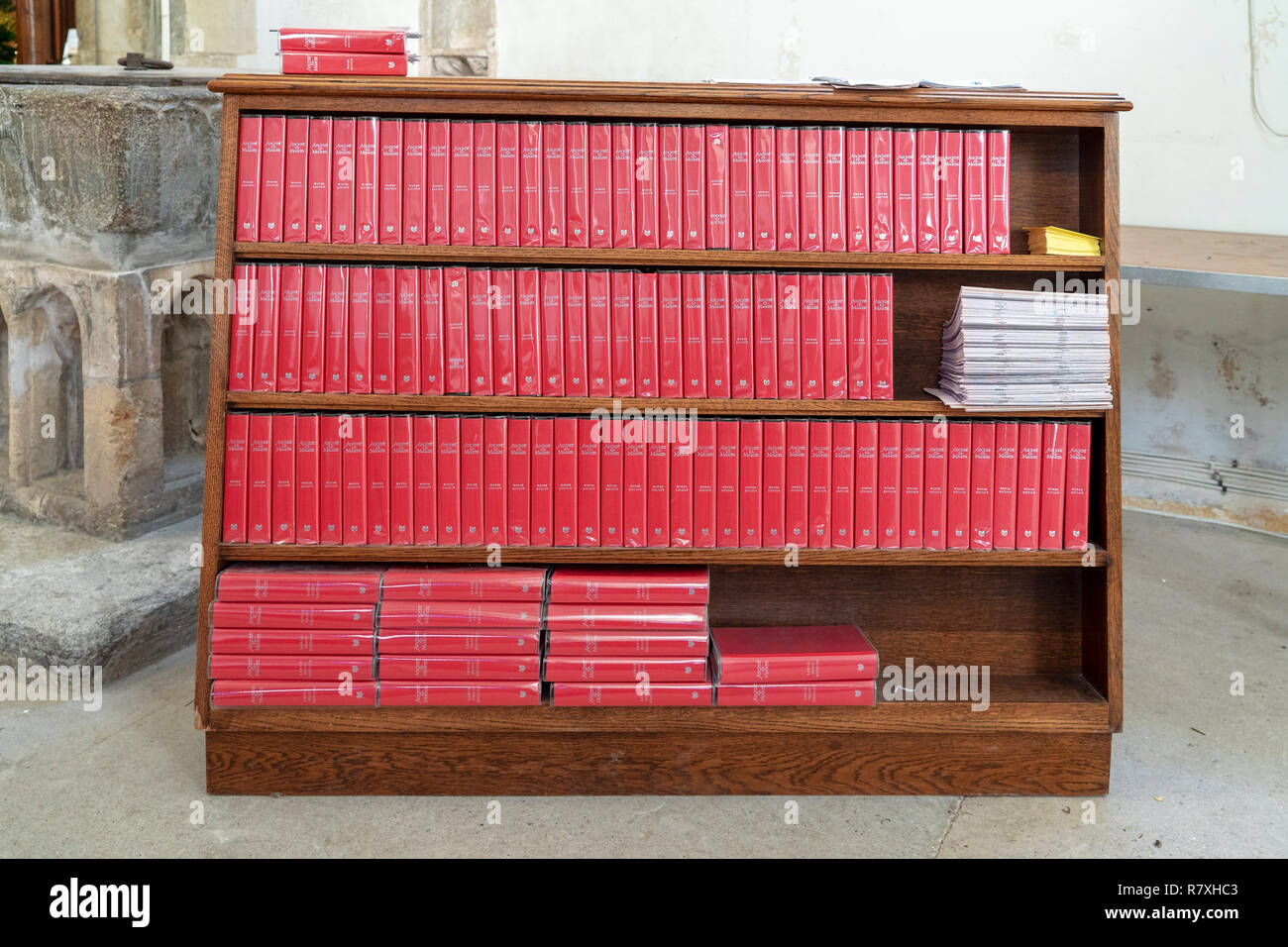 Lines of red hymn books on wooden shelves Stock Photo - Alamy