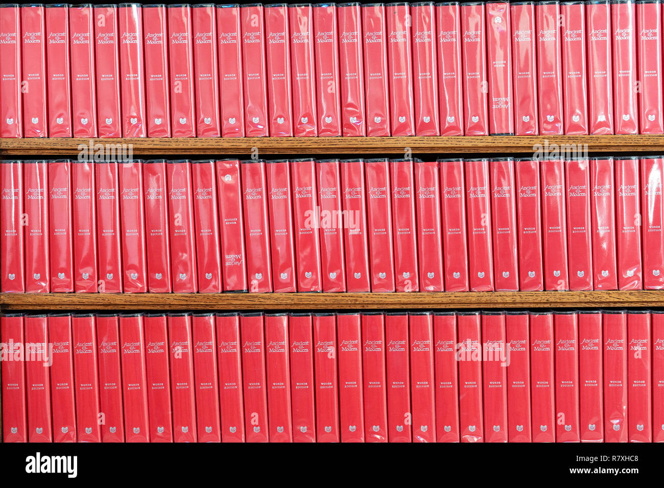 Lines of red hymn books on wooden shelves Stock Photo - Alamy