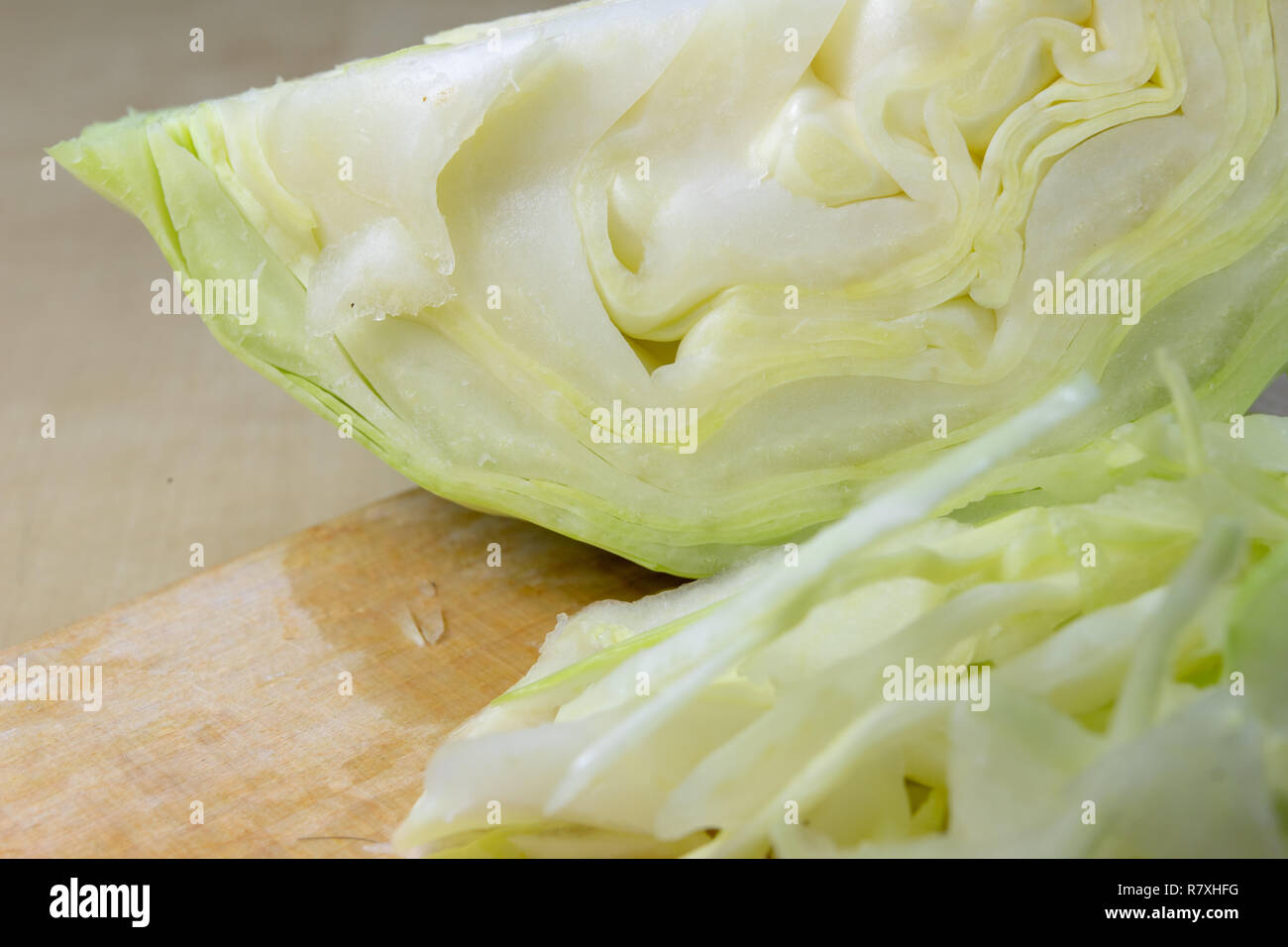 Fresh white cabbage cut into strips on the kitchen table. Vegetables ...