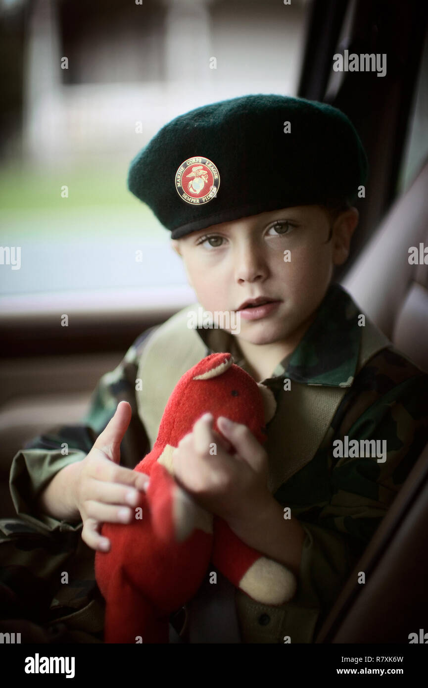 Boy in army uniform holding bear Stock Photo - Alamy