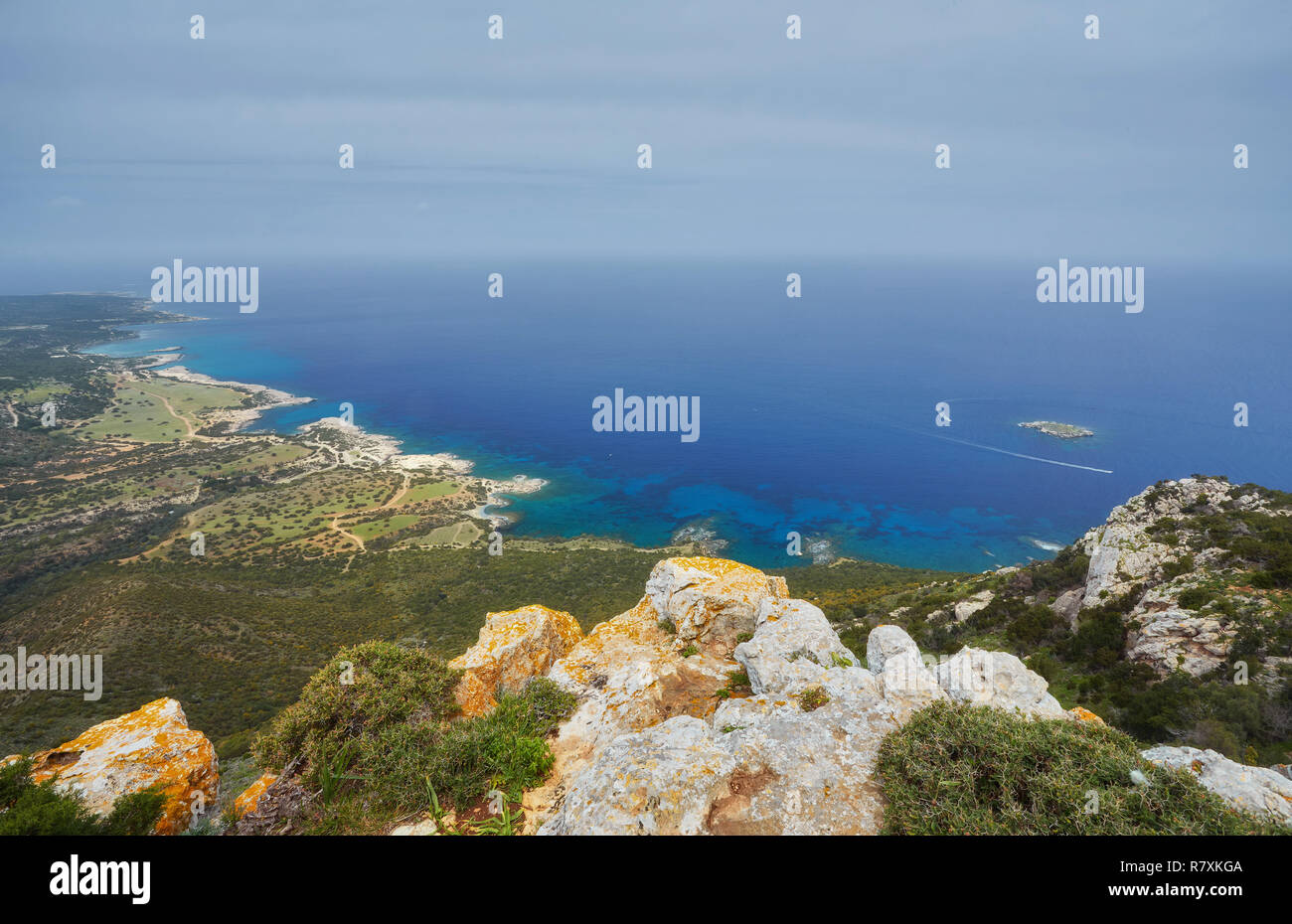 Stones and rocks in forefront with creamy surf ebbing and flowing on ...