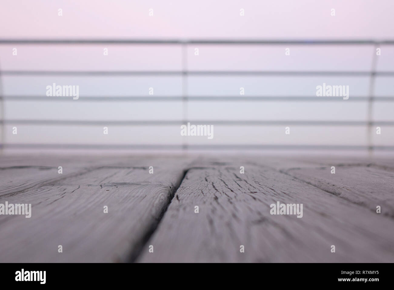 Wooden deck overlooking the sea sunrise with shallow depth of field ...