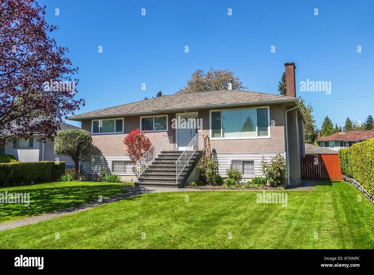 Average residential house with concrete pathway over front yard on ...