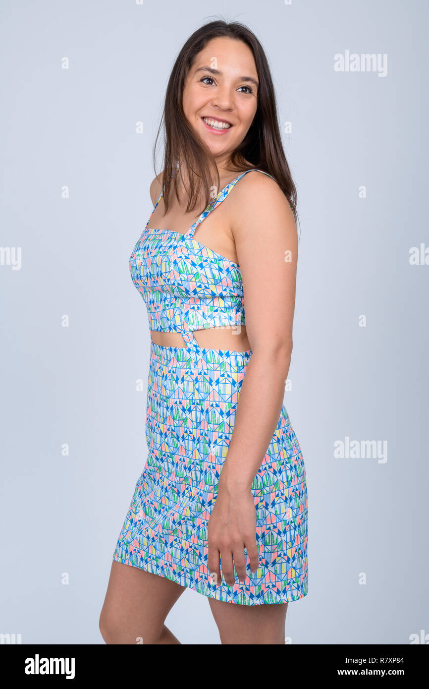 Young happy multi-ethnic woman smiling and thinking while wearing ...