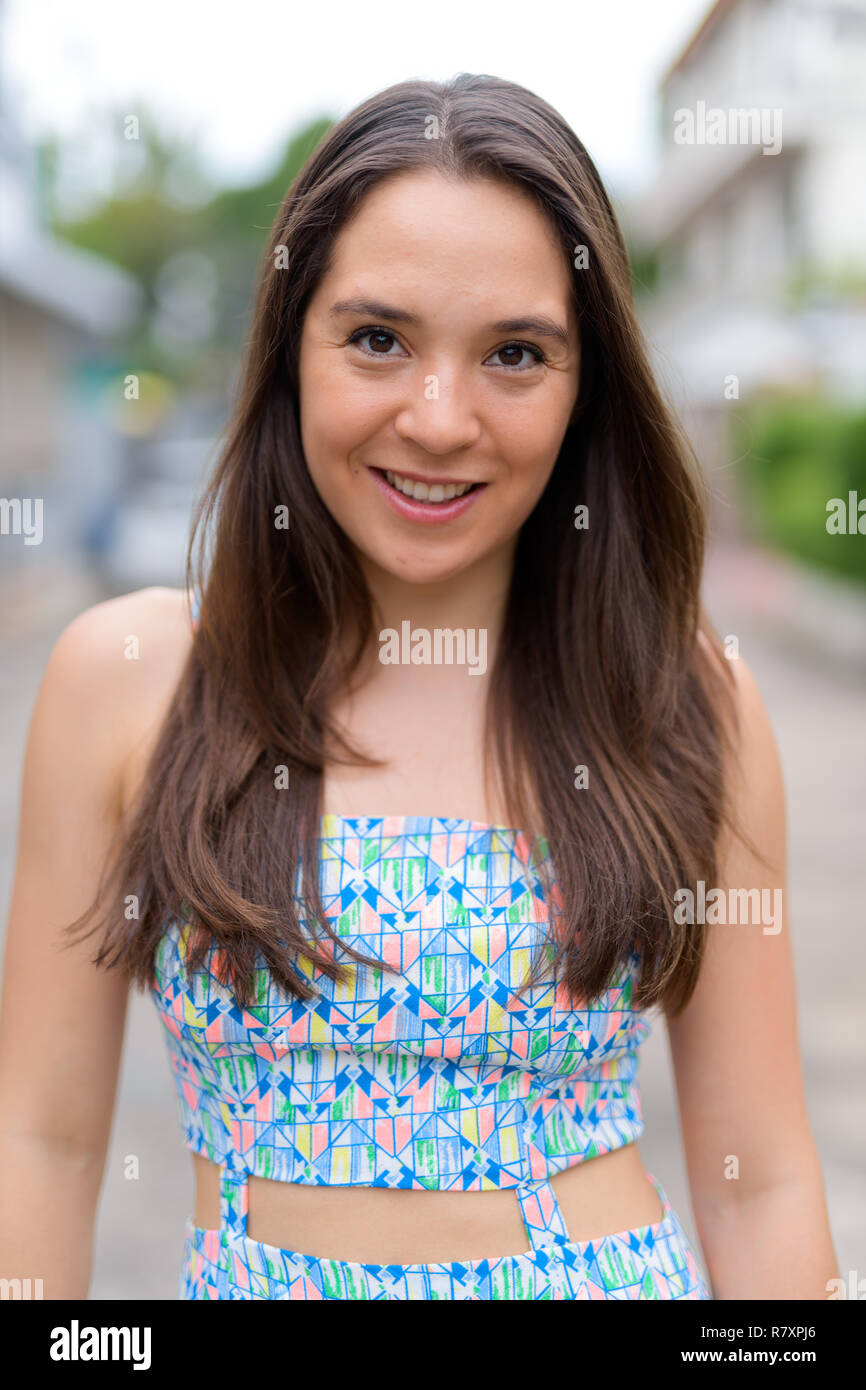 Beautiful happy multi-ethnic woman smiling in the streets outdoors ...