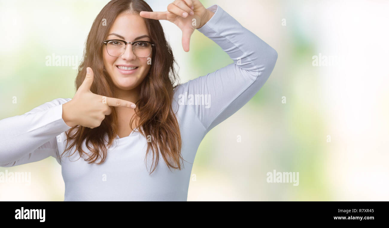 Beautiful plus size young woman over isolated background smiling making ...