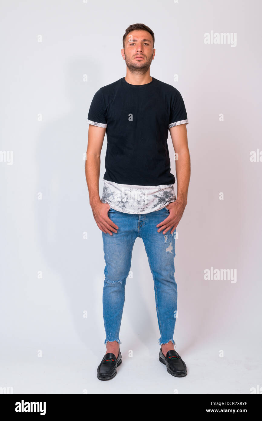Full body shot of handsome bearded Persian man standing against white ...