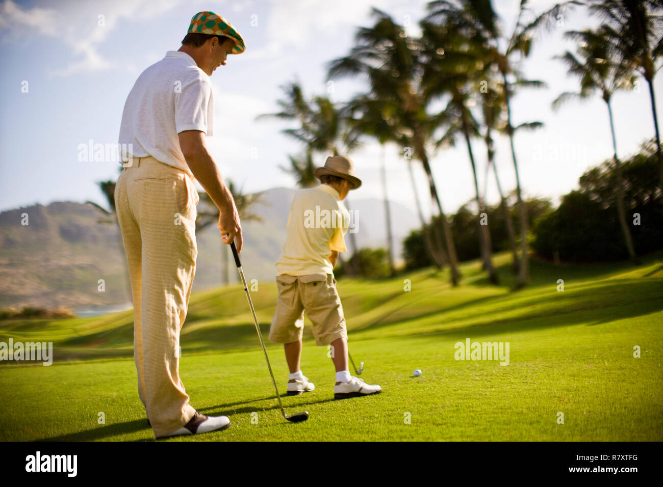 Child golfer and teacher hi-res stock photography and images - Alamy