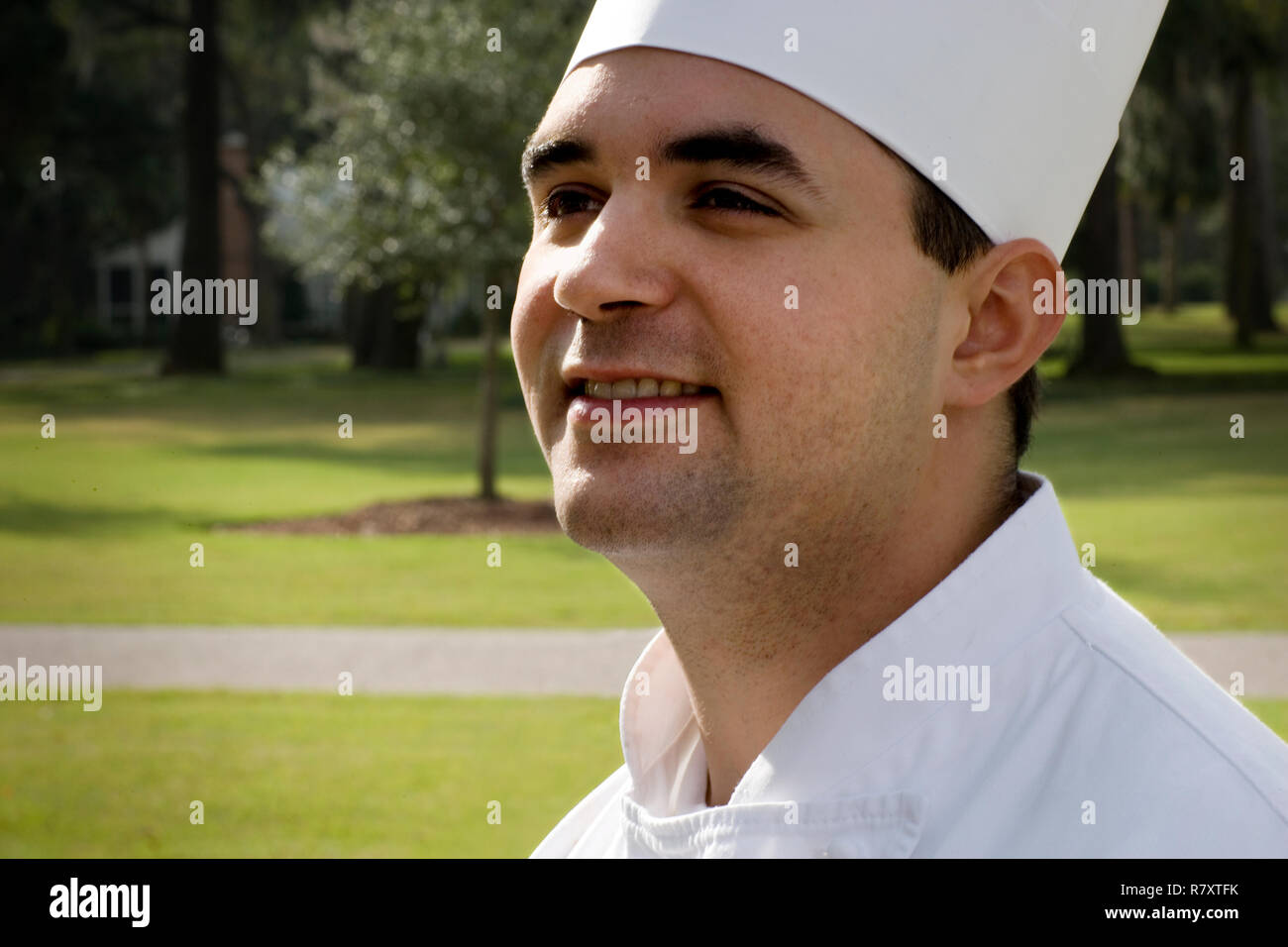 Young adult male chef standing outside Stock Photo - Alamy