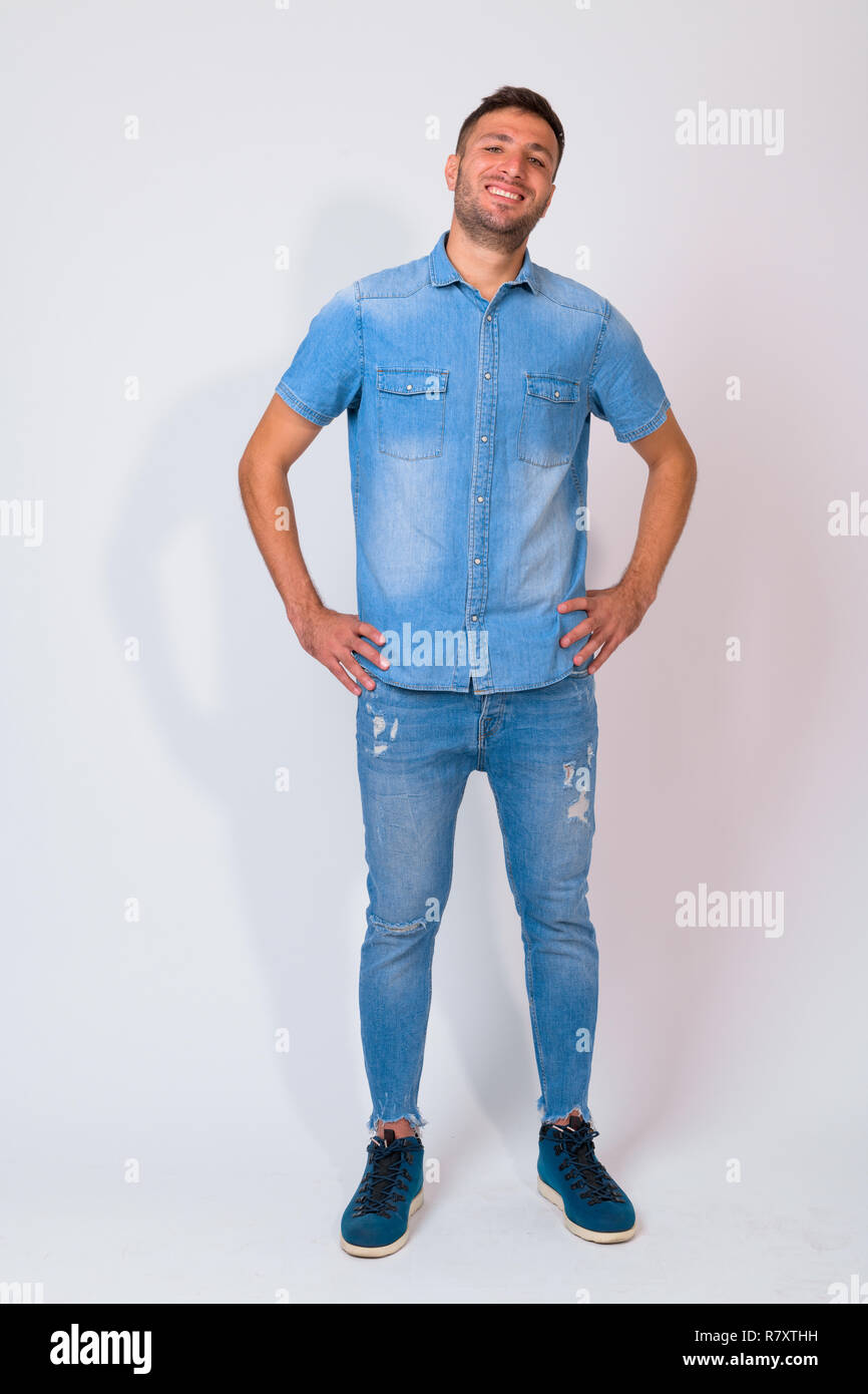 Full body shot of happy bearded Persian man smiling against white ...